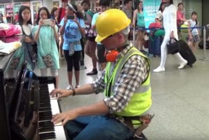 Construction worker plays boogie-woogie piano jam in airport