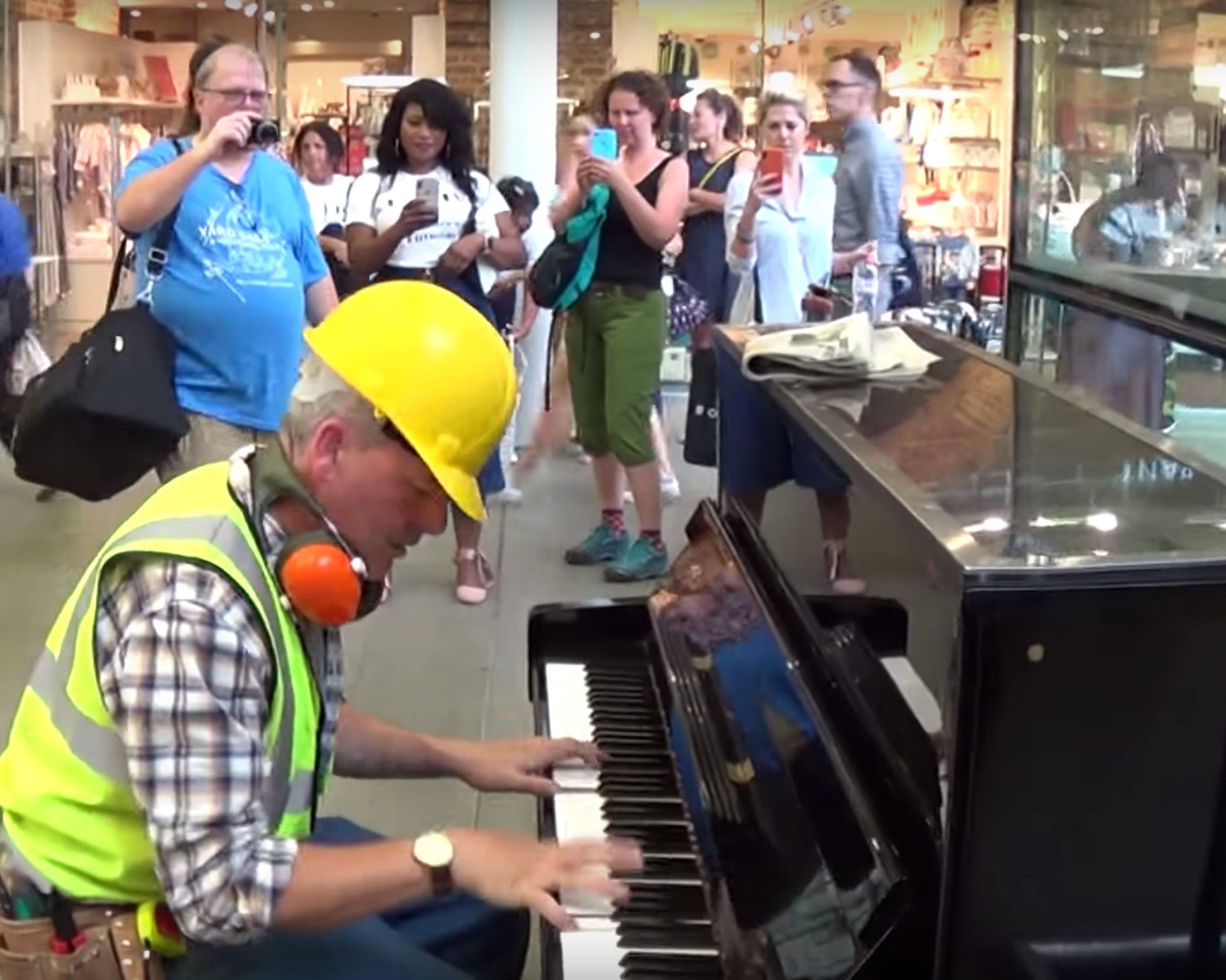 Construction worker plays boogie-woogie piano jam in airport