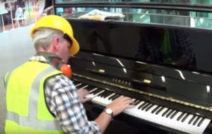 Construction worker plays boogie-woogie piano jam in airport