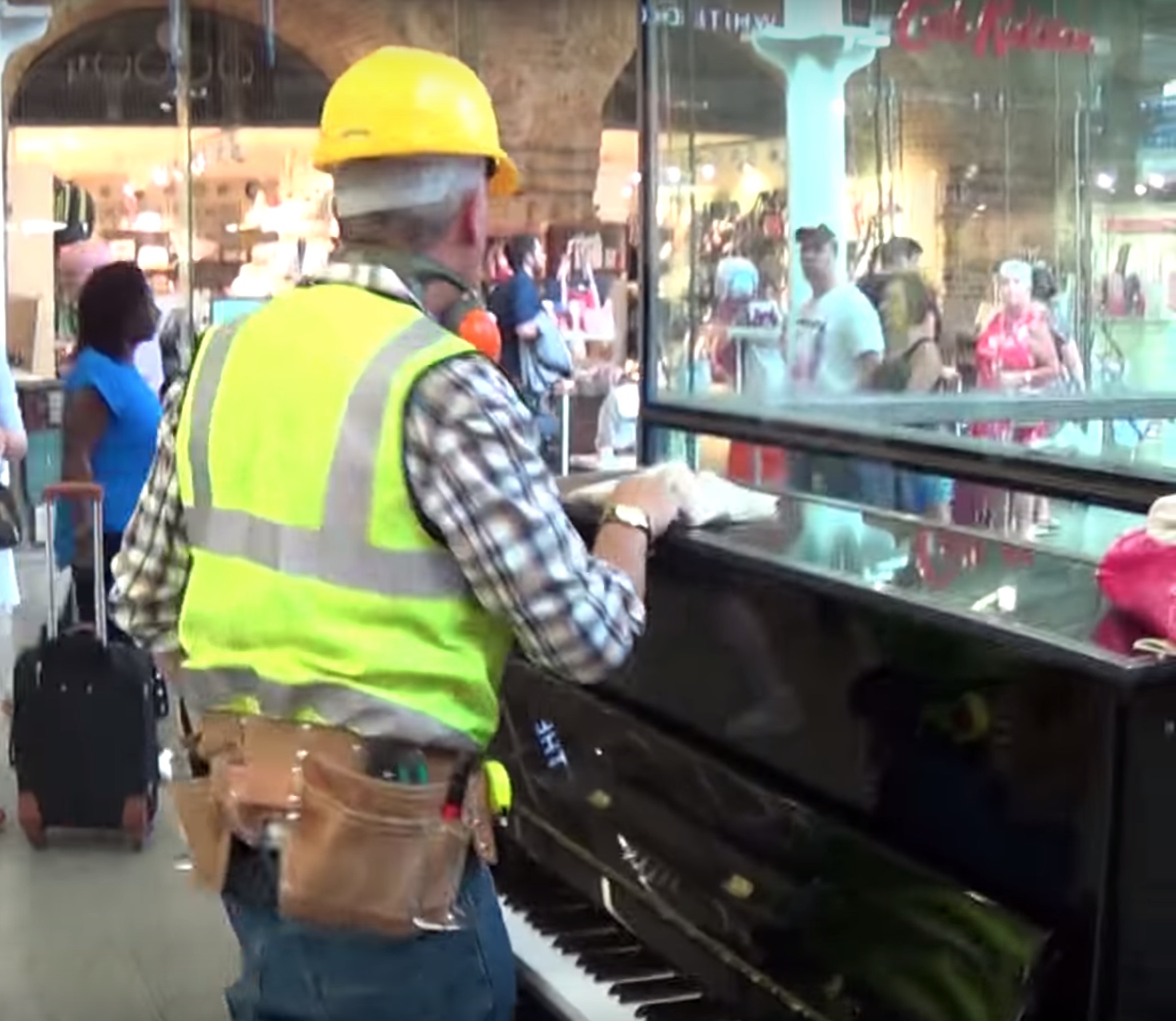 Construction worker plays boogie-woogie piano jam in airport