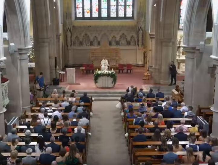 Couple cry when guests interrupt wedding ceremony to sing