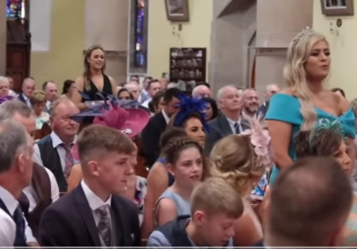 Couple cry when guests interrupt wedding ceremony to sing