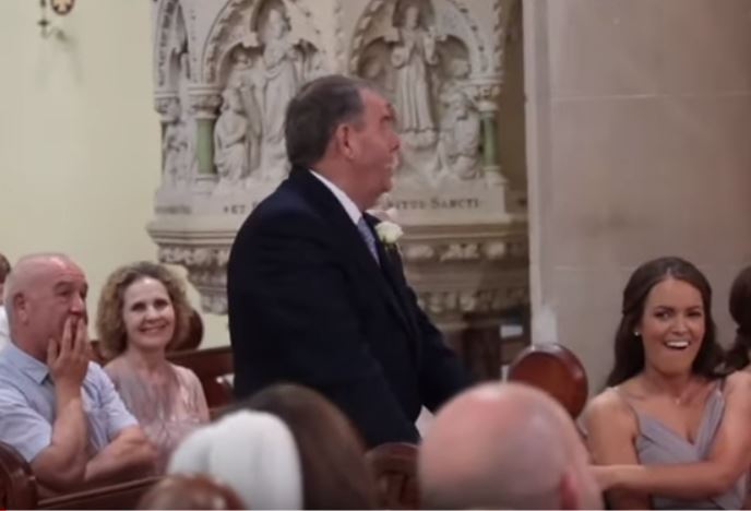 Couple cry when guests interrupt wedding ceremony to sing