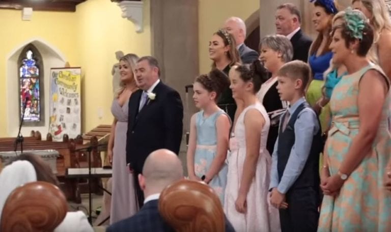 Couple cry when guests interrupt wedding ceremony to sing