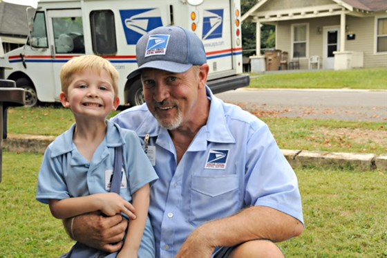 Mailman gets help on job from 4-year-old pint-sized boy in matching outfit