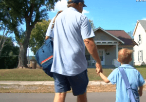 Mailman gets help on job from 4-year-old pint-sized boy in matching outfit