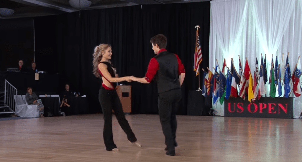 Swing dancing duo steps on dance floor – lights it up with hypnotic ...