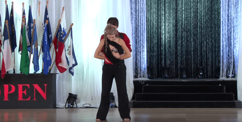 Swing dancing duo steps on dance floor – lights it up with hypnotic ...