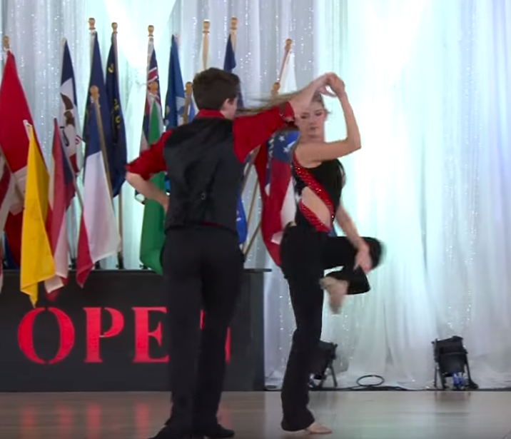 Swing dancing duo steps on dance floor – lights it up with hypnotic ...