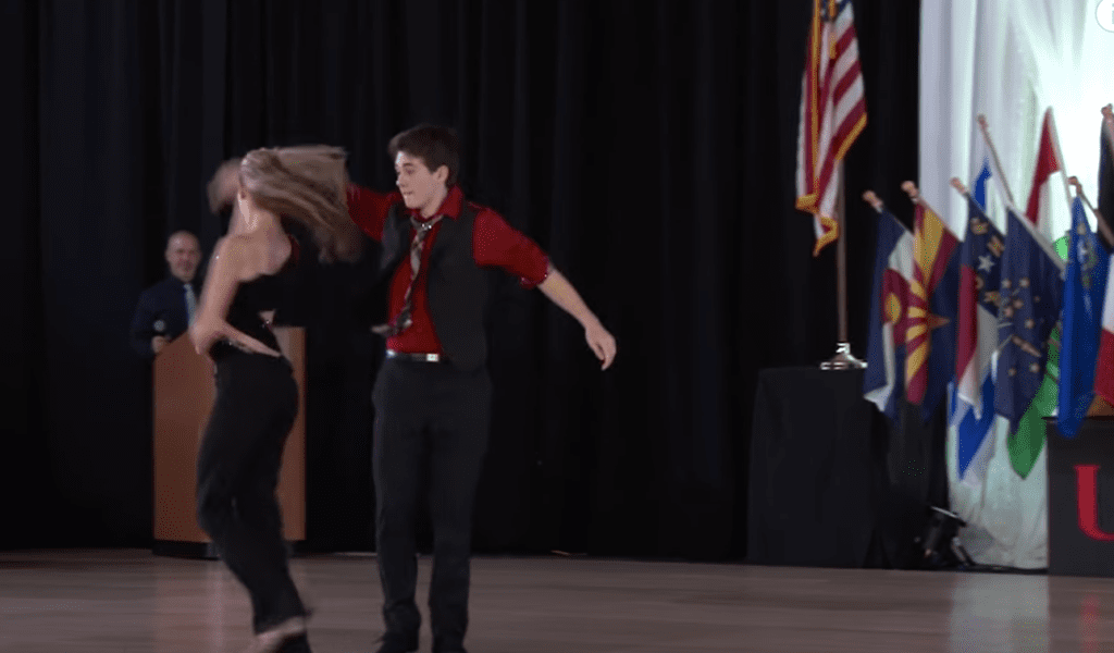 Swing dancing duo steps on dance floor – lights it up with hypnotic ...