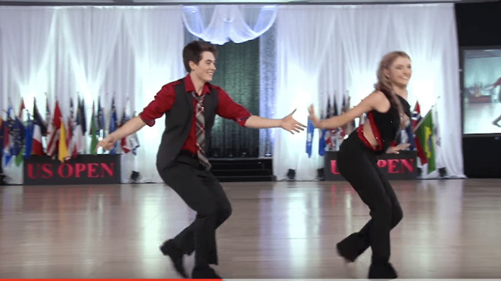 Swing dancing duo steps on dance floor – lights it up with hypnotic ...