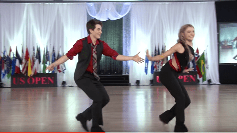 Swing dancing duo steps on dance floor – lights it up with hypnotic ...