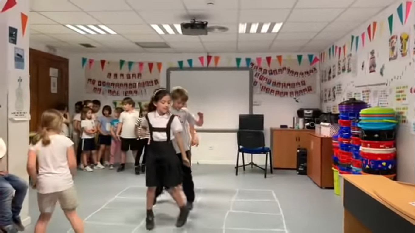 Teacher demonstrates tough rhythmic dance to elementary school kids ...