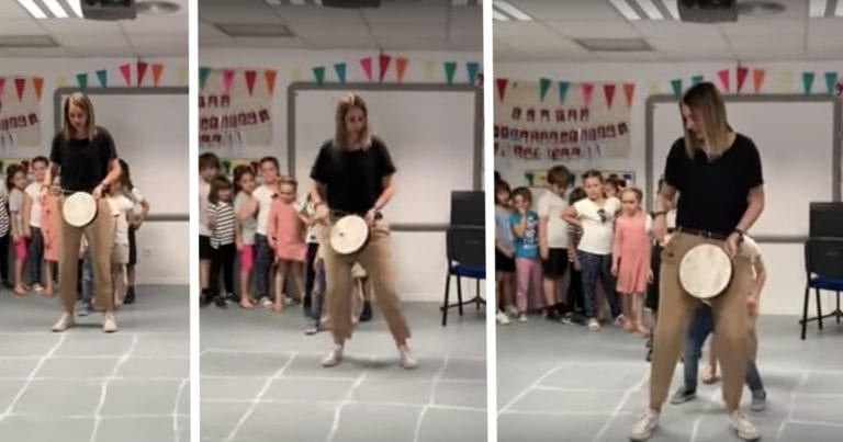 Teacher demonstrates tough rhythmic dance to elementary school kids ...