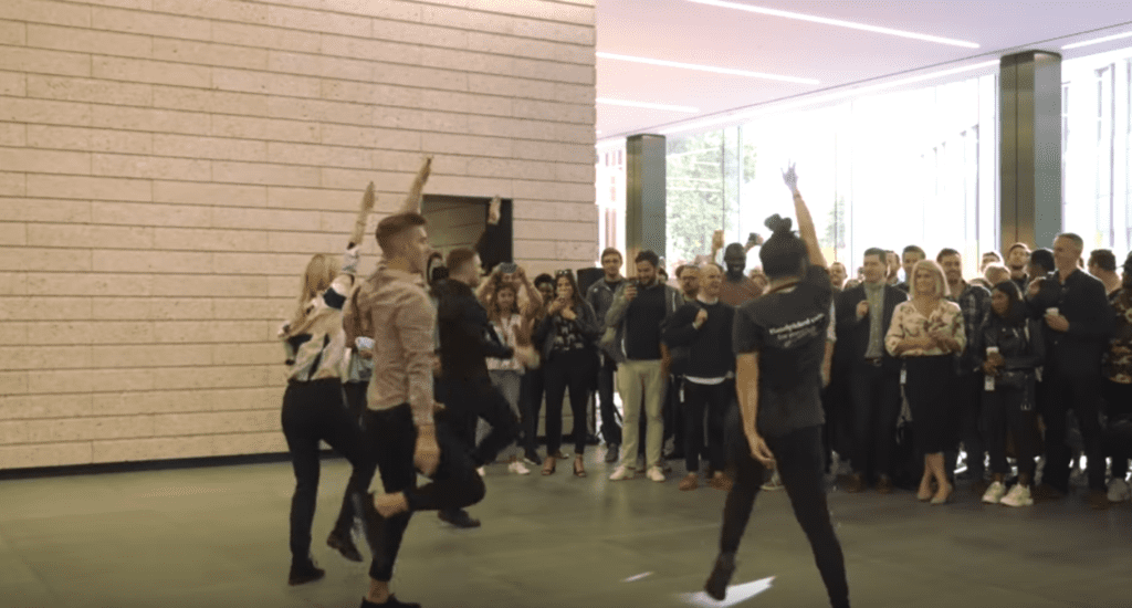 Workers gather around to cut ribbon for new office – then ’employee ...