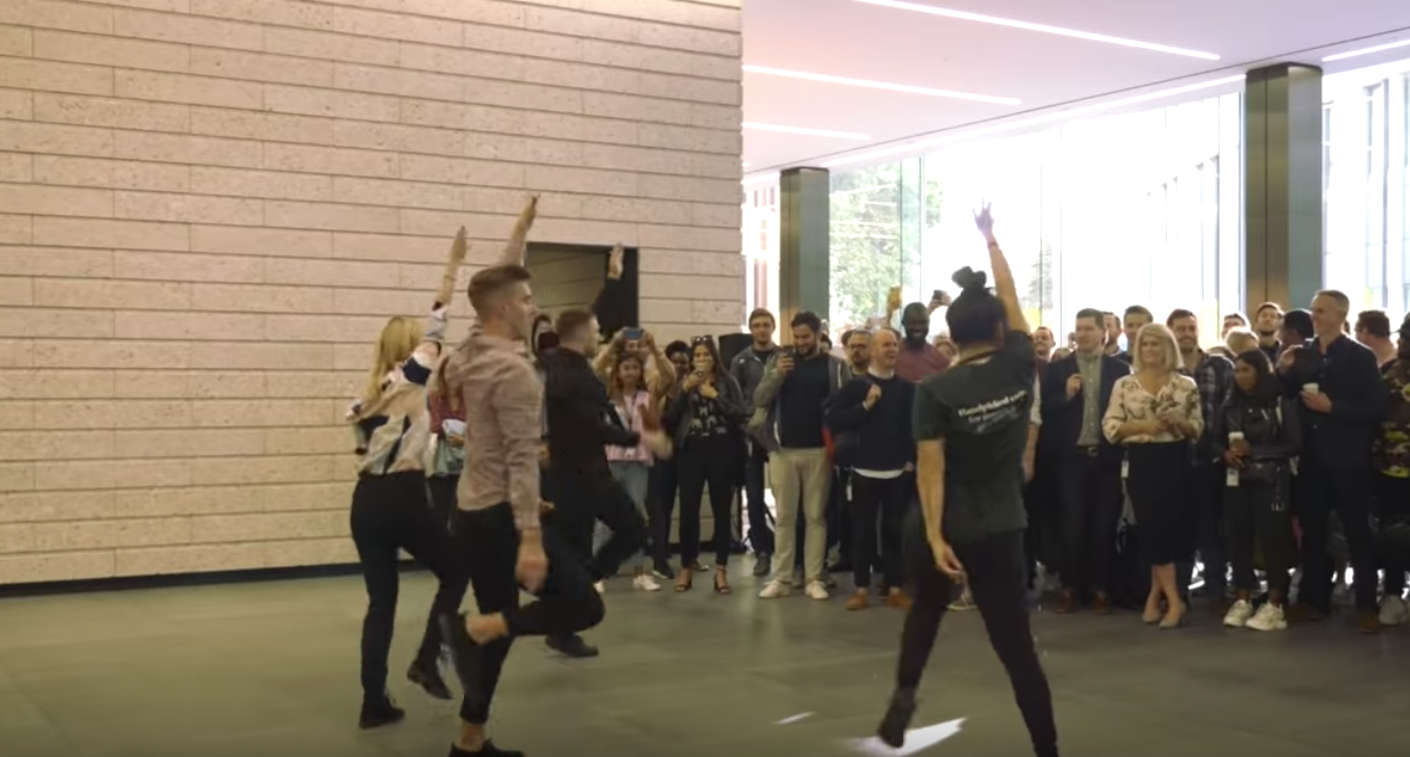 Workers gather around to cut ribbon for new office – then ’employee ...