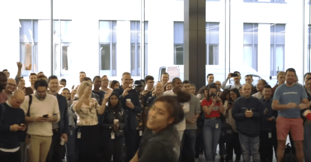 Workers gather around to cut ribbon for new office – then ’employee ...