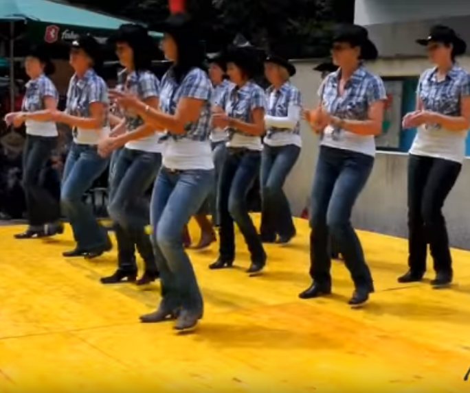 Crowd Gathers For Women’s Carefully Timed Line Dance