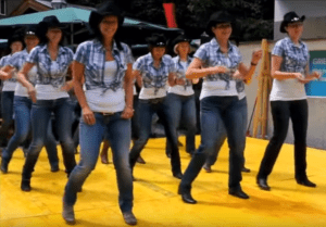 Crowd Gathers For Women’s Carefully Timed Line Dance