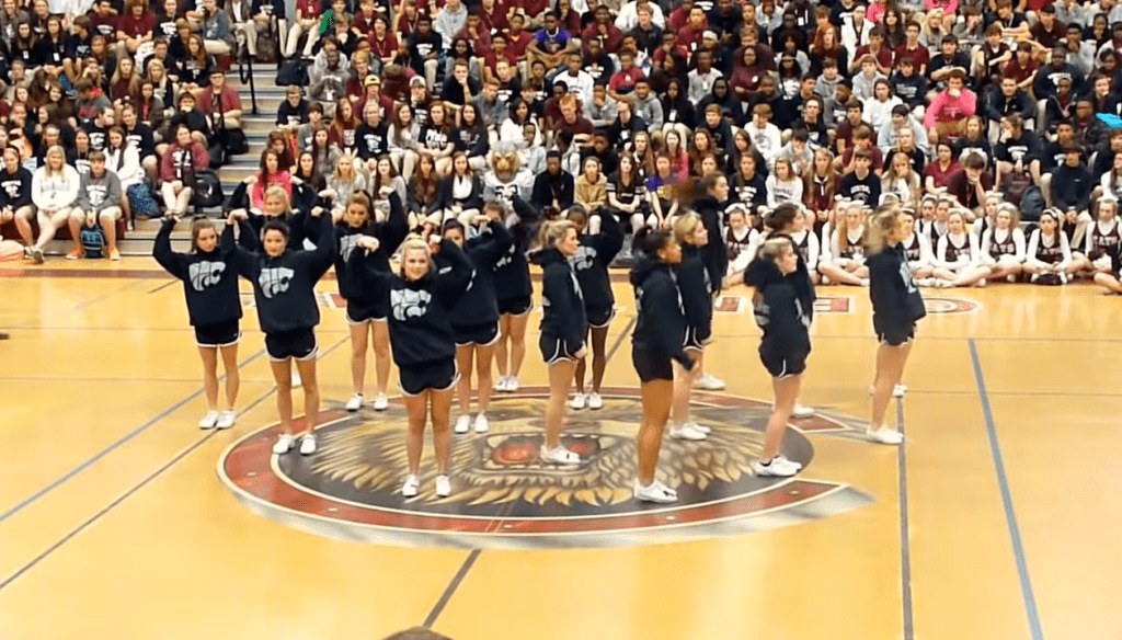 Cheerleaders strike a pose then have crowd glued to their every move