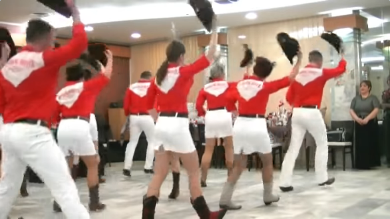 Country line dancers adjust their hats – then break out slick moves in ...