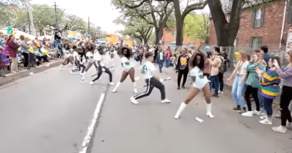 High school marching band flies onto parade path with incredible routine