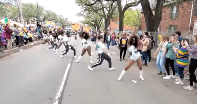 High school marching band flies onto parade path with incredible routine