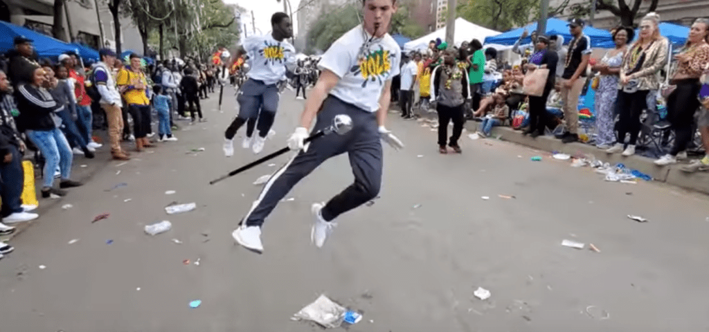 High school marching band flies onto parade path with incredible routine