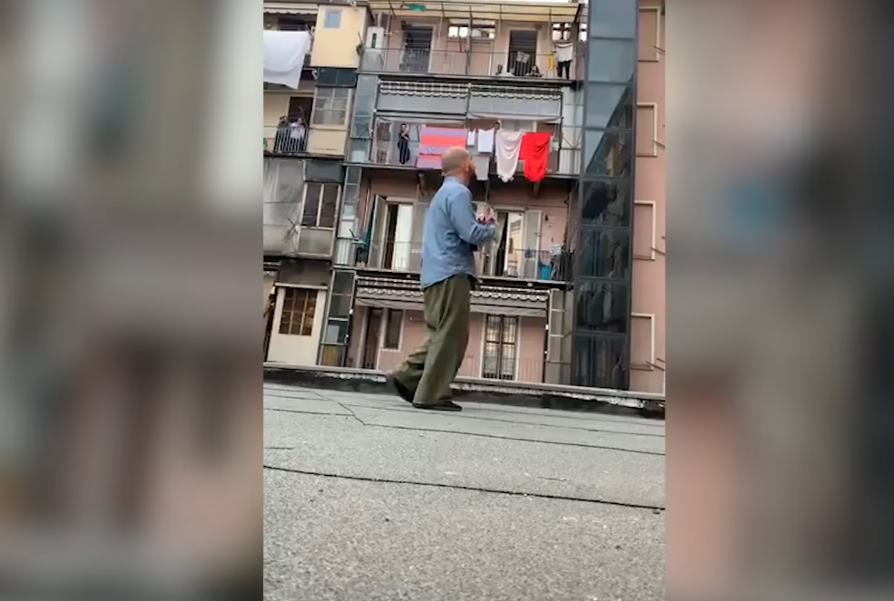 Video captures Italian man setting off community singing to lift spirits