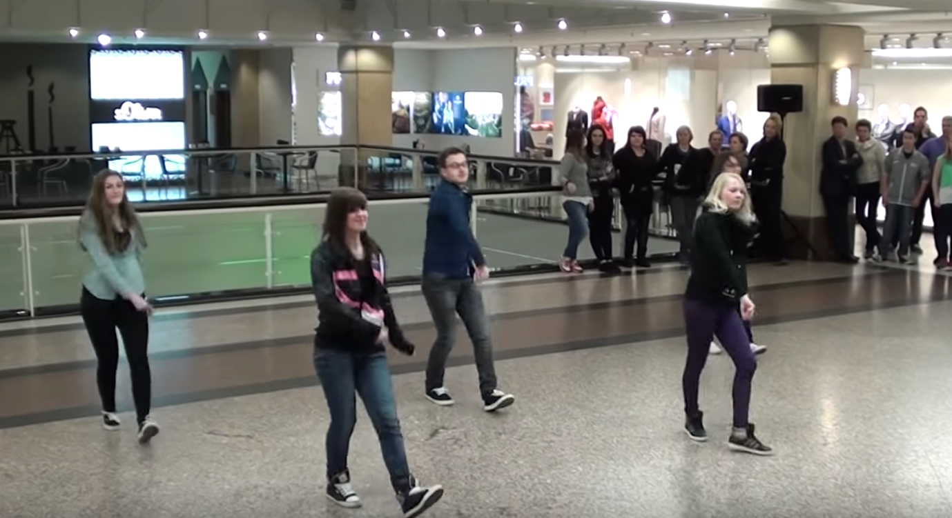 Woman in tears during flash mob when boyfriend emerges from dancers