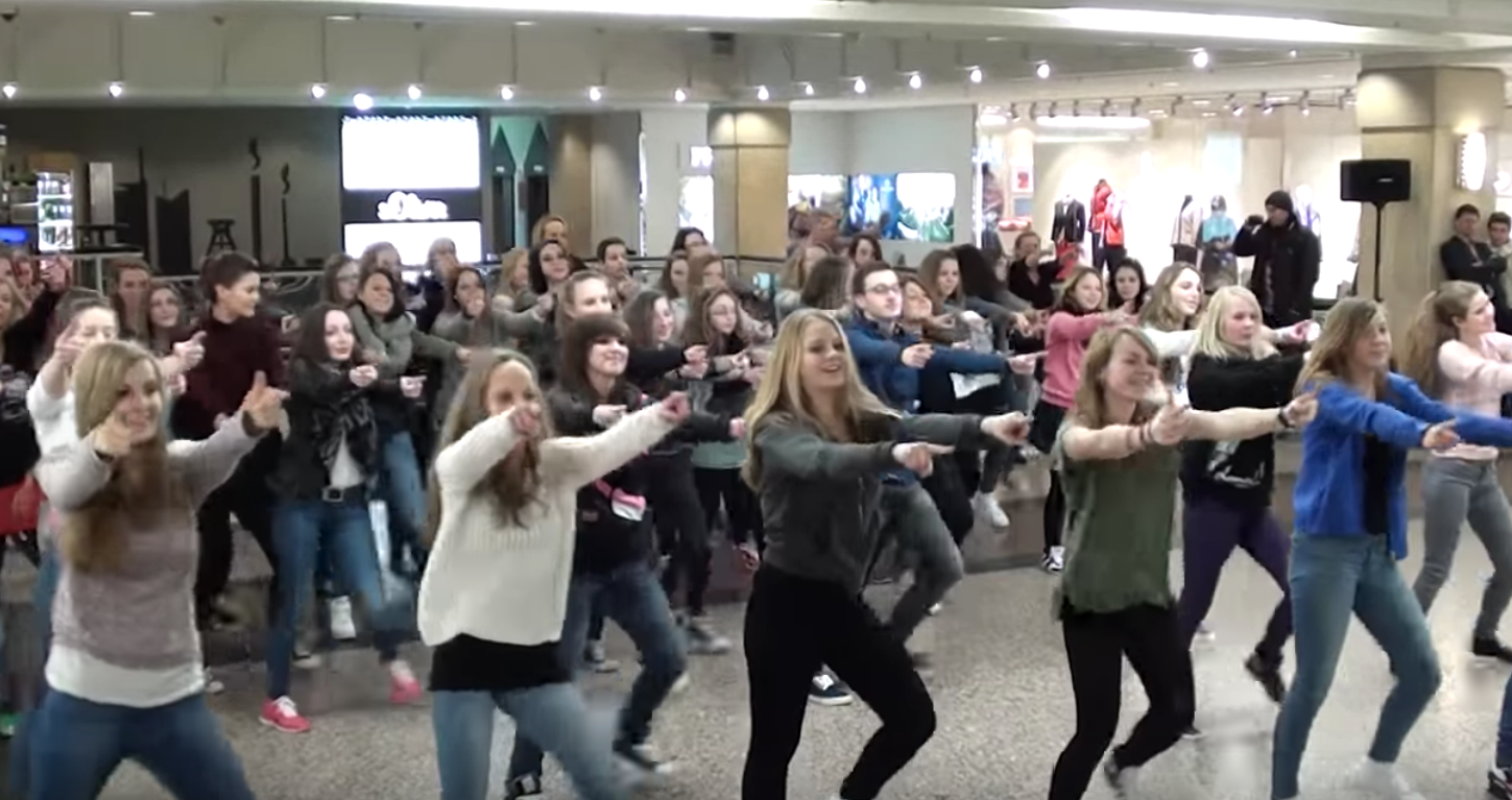 Woman in tears during flash mob when boyfriend emerges from dancers