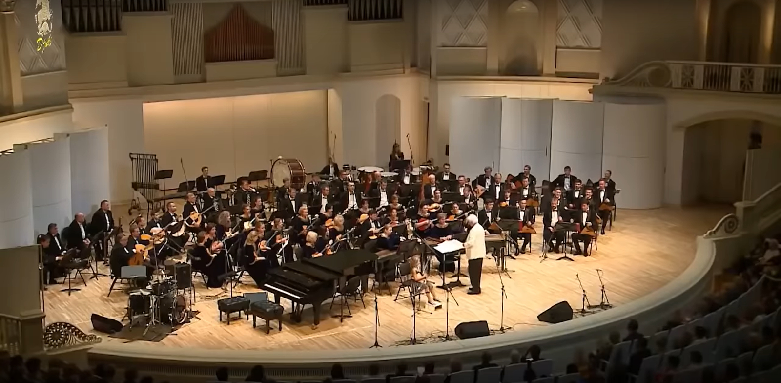 Amazing 7-year-old musician leads adult orchestra in song