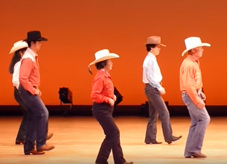 Japanese Men And Women Entertain With Country Line Dance