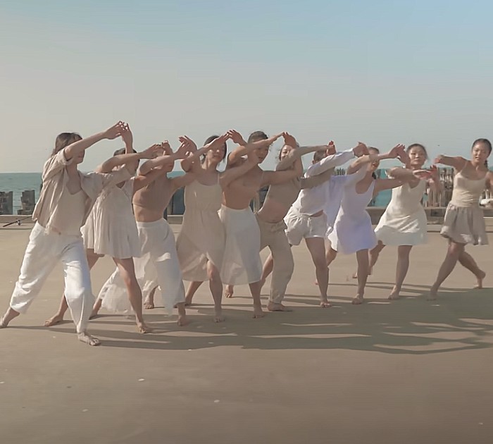 Dancers light up walkway by the ocean with moving routine