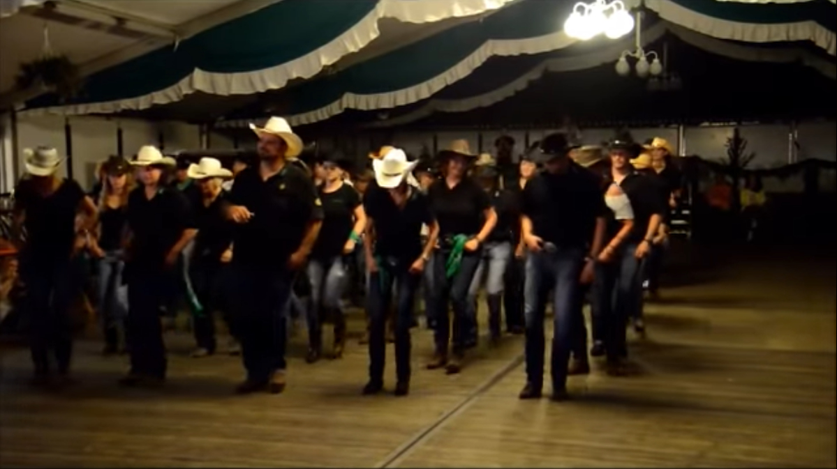 Cowboys and cowgirls shake up dance floor with perfect country line dance