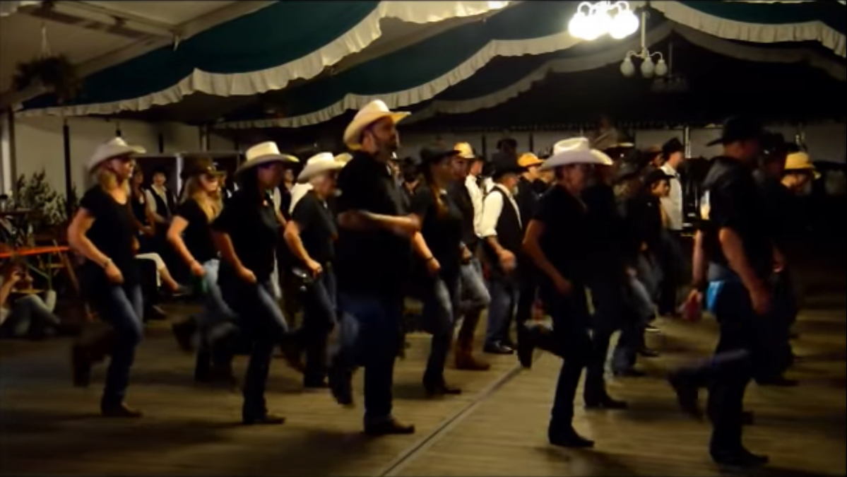 Cowboys and cowgirls shake up dance floor with perfect country line dance