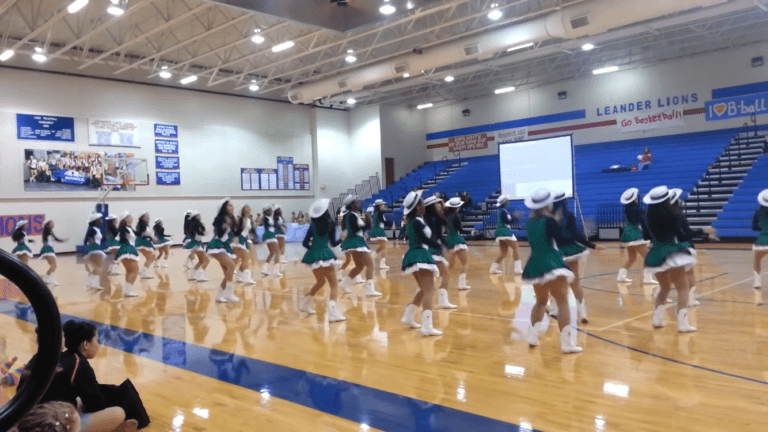 Cheerleaders take over gym floor with epic high-kick routine