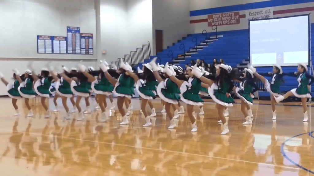 Cheerleaders take over gym floor with epic high-kick routine