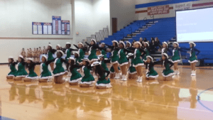 Cheerleaders take over gym floor with epic high-kick routine