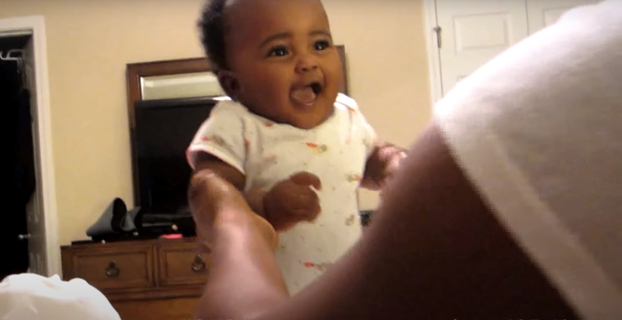 Happy baby shares contagious hearty laugh before she falls over