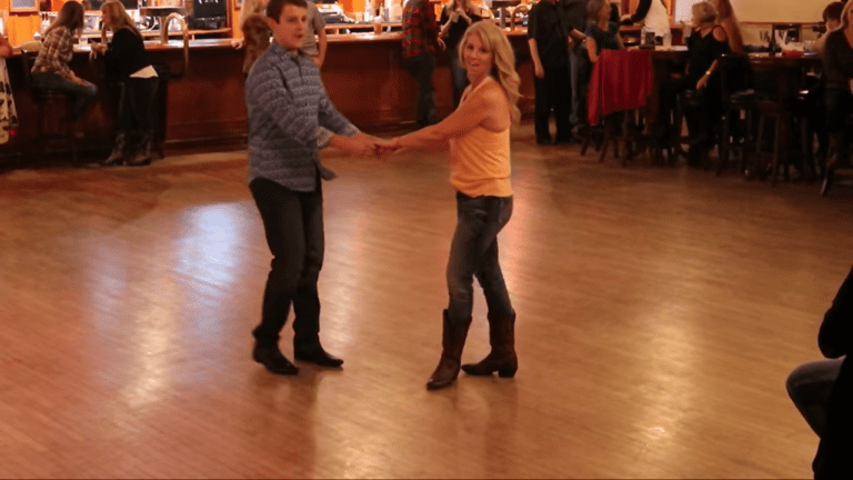 Couple cozies up on dance floor for smooth first country dance