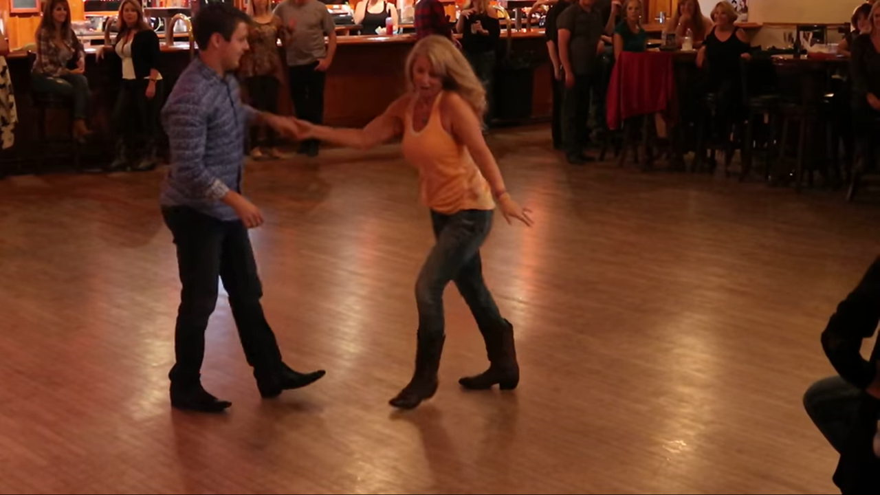 Couple cozies up on dance floor for smooth first country dance