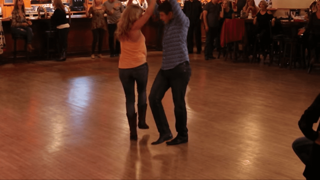 Couple cozies up on dance floor for smooth first country dance