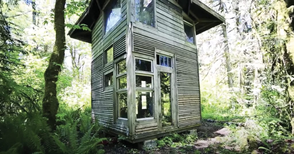 Man shows inside his cabin the woods built entirely from recycled material