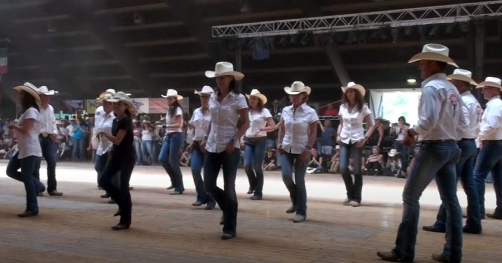100+ performers do rollicking country line dance in sync