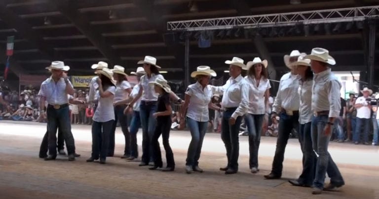 100+ performers do rollicking country line dance in sync