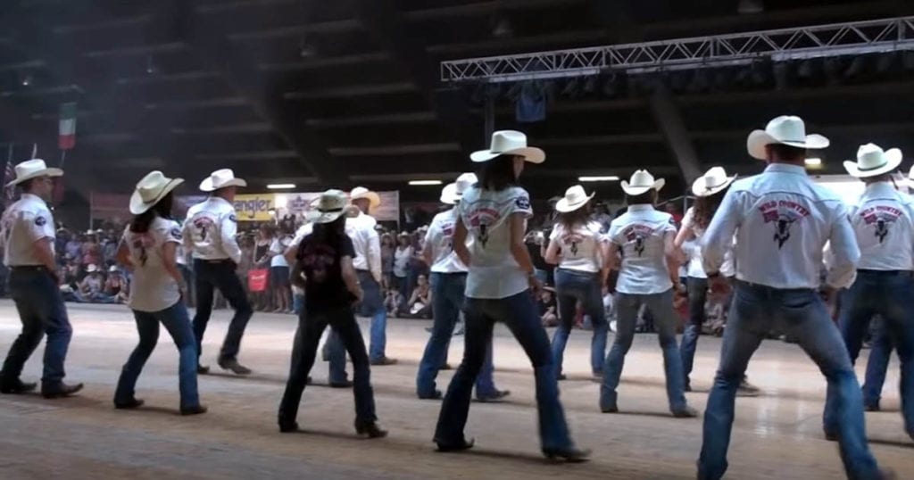 100+ performers do rollicking country line dance in sync