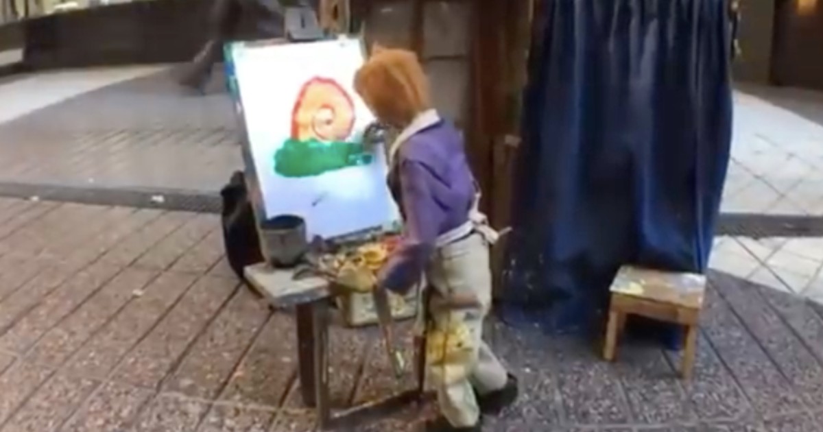 Puppet painter steps in front of blank canvas then delivers a work of art