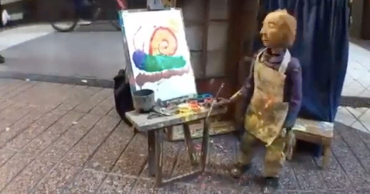 Puppet painter steps in front of blank canvas then delivers a work of art
