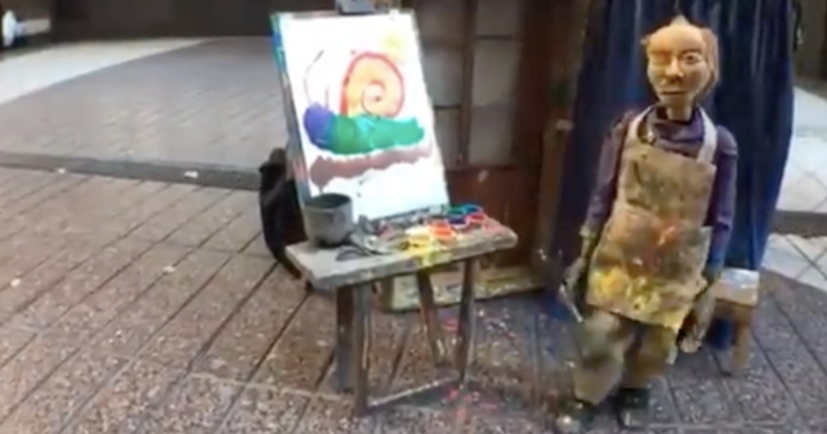 Puppet painter steps in front of blank canvas then delivers a work of art